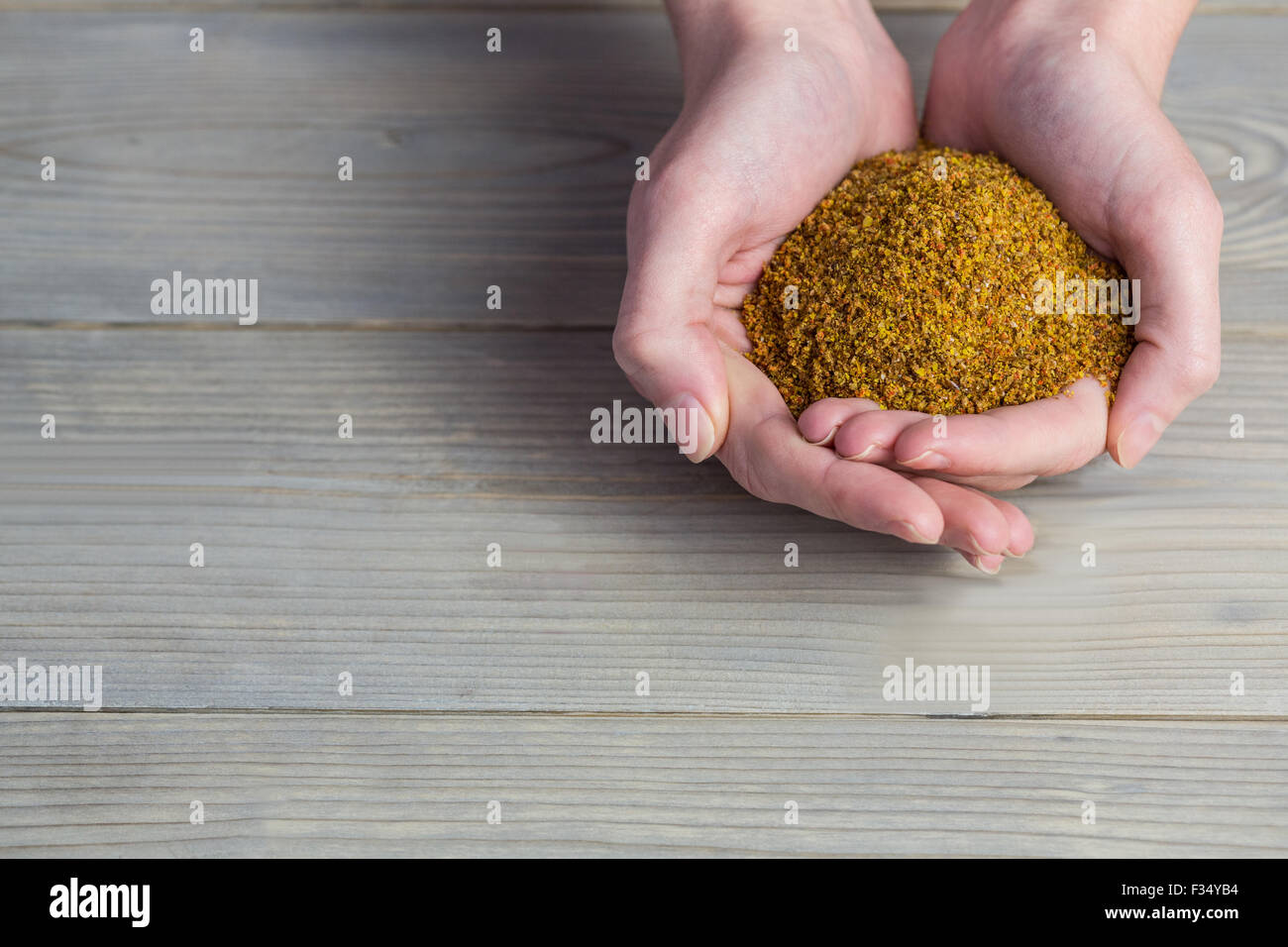 Woman showing handful of milled seed Stock Photo - Alamy