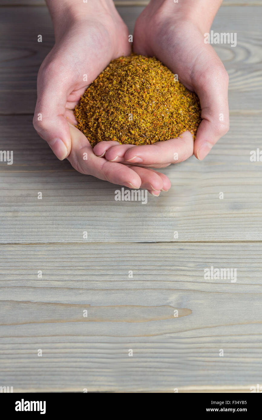 Woman showing handful of milled seed Stock Photo - Alamy