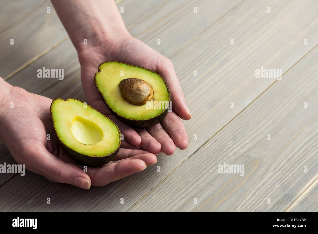 Woman showing fresh avocado hi-res stock photography and images - Alamy
