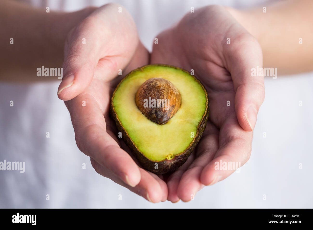 Female hands holding avocado hi-res stock photography and images - Alamy