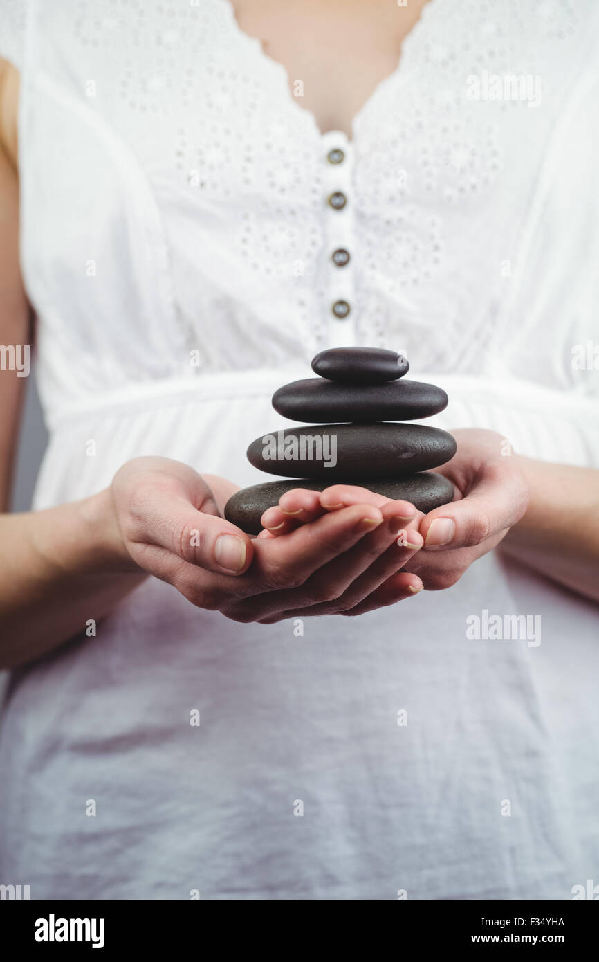 Woman holding black stones Stock Photo - Alamy