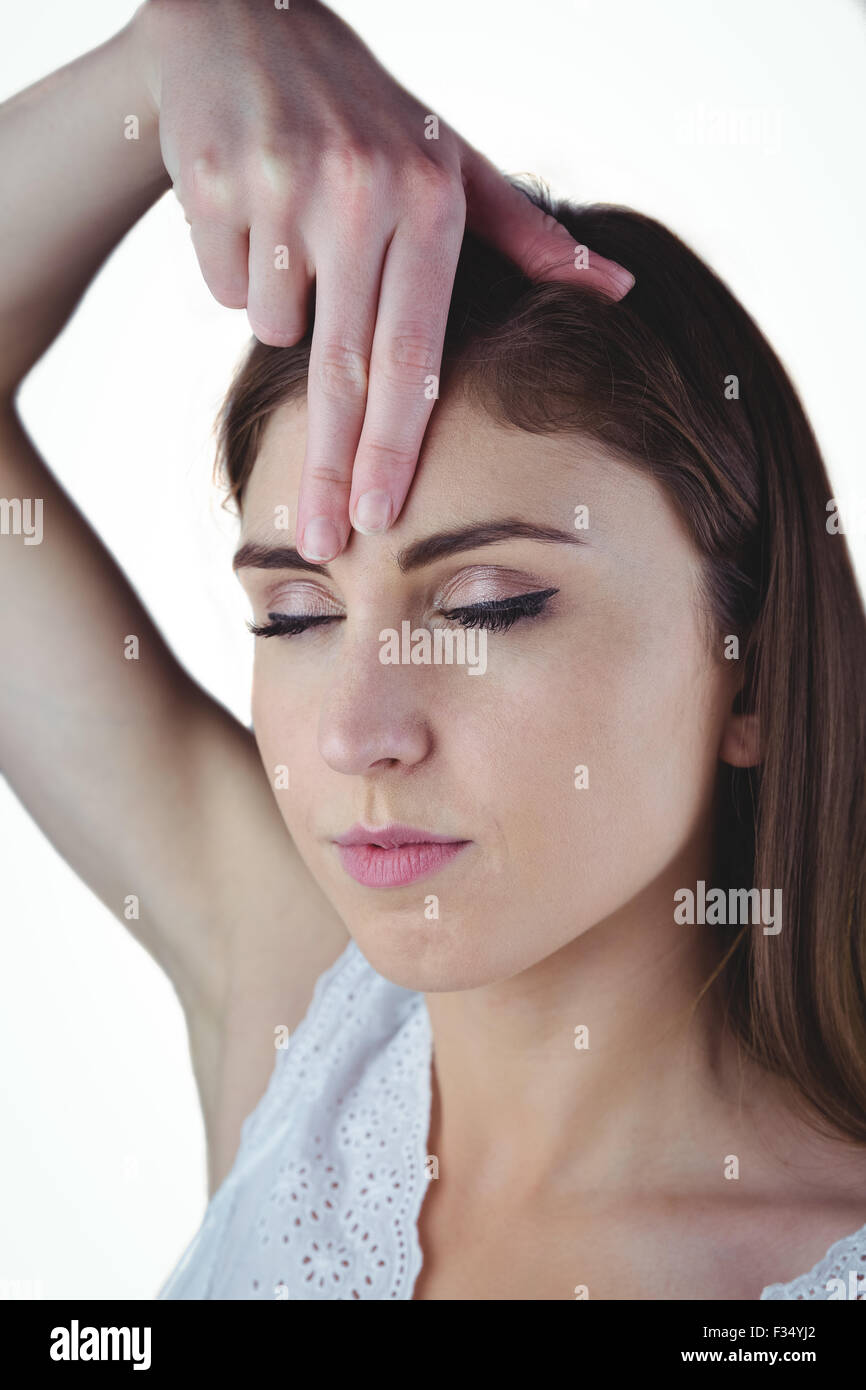 Woman meditating with hand on forehead Stock Photo - Alamy