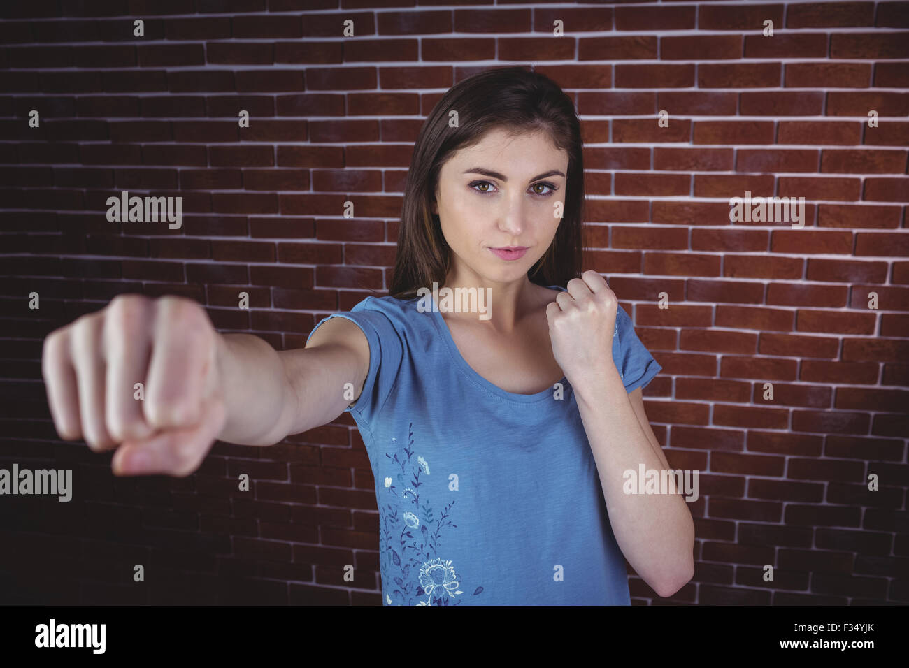 Pretty brunette punching to camera Stock Photo - Alamy