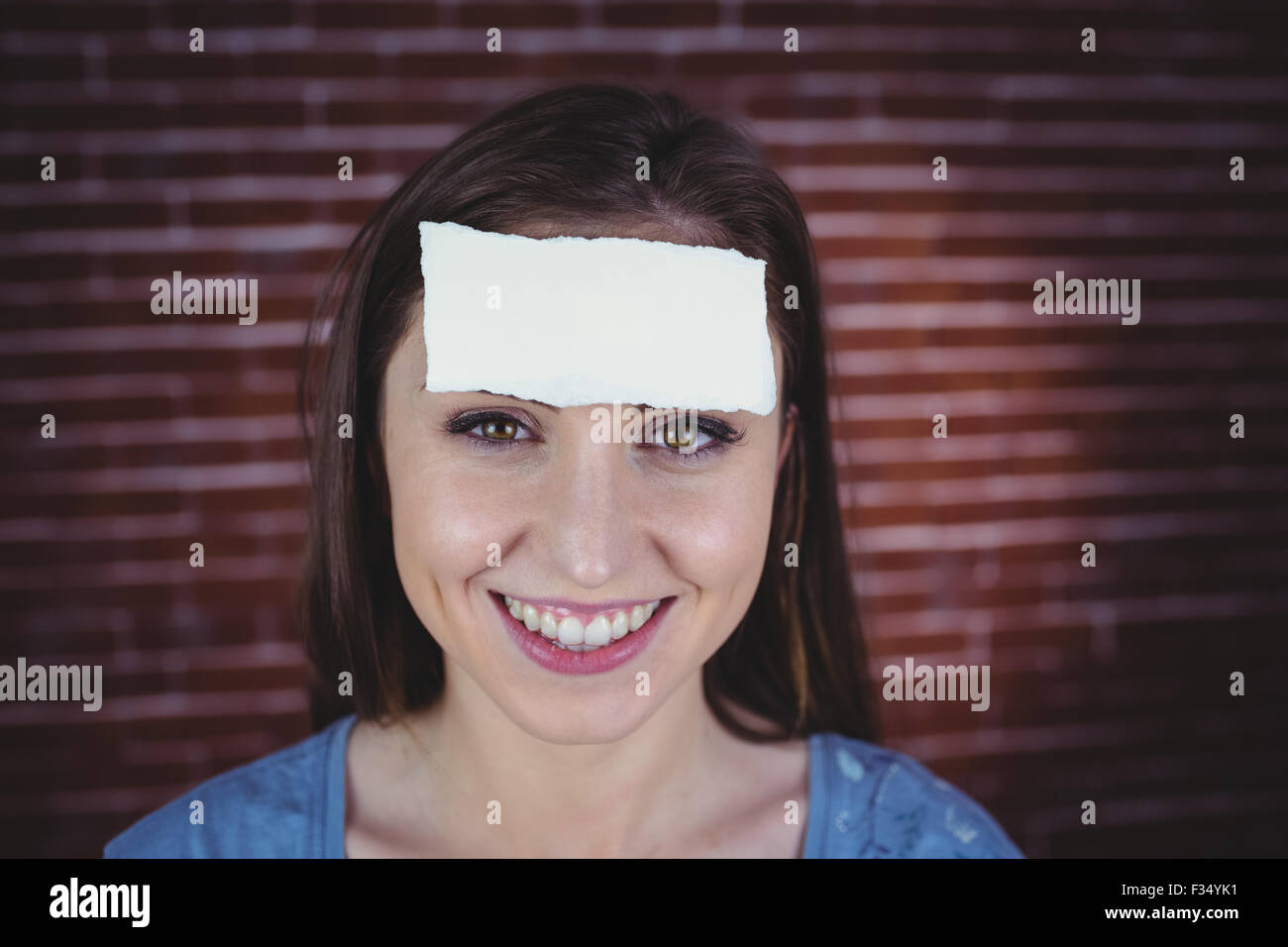 Pretty brunette with paper on head Stock Photo - Alamy