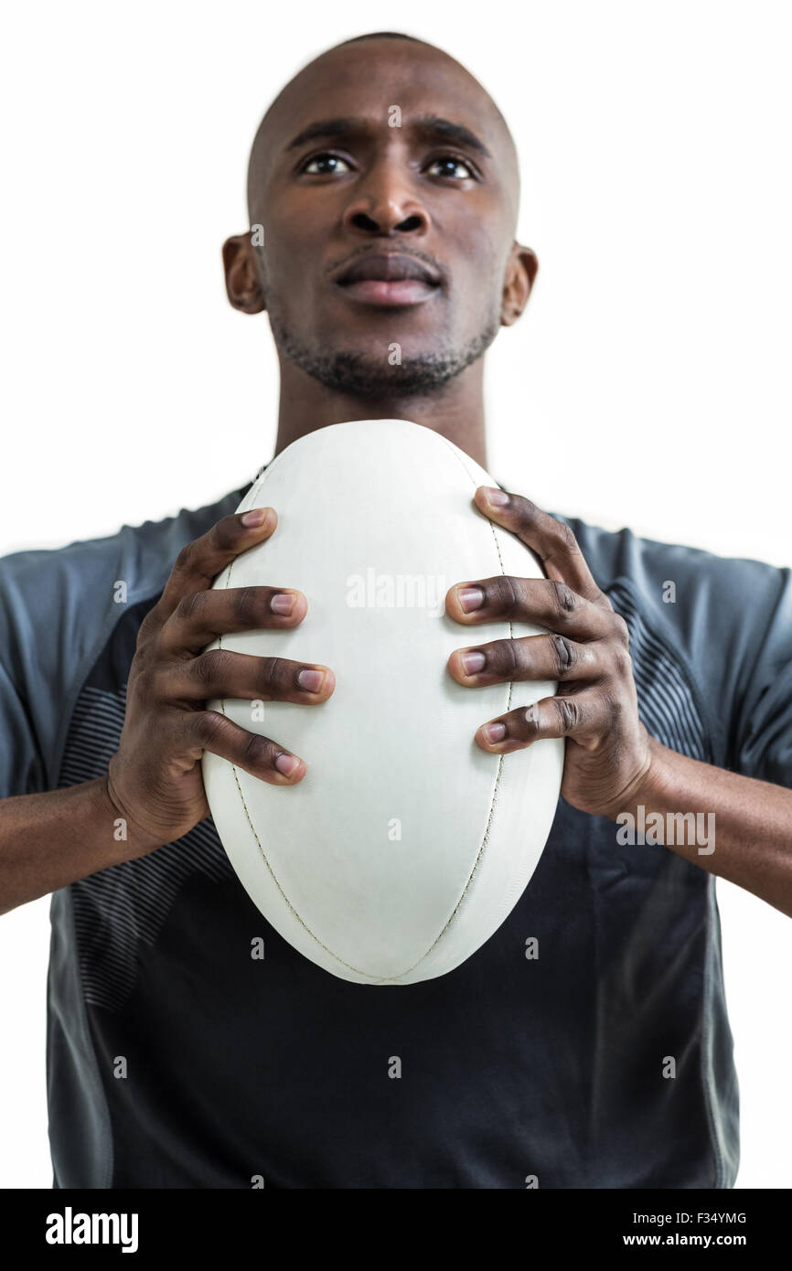 Cropped image of sportsman pressing rugby ball while looking up Stock ...