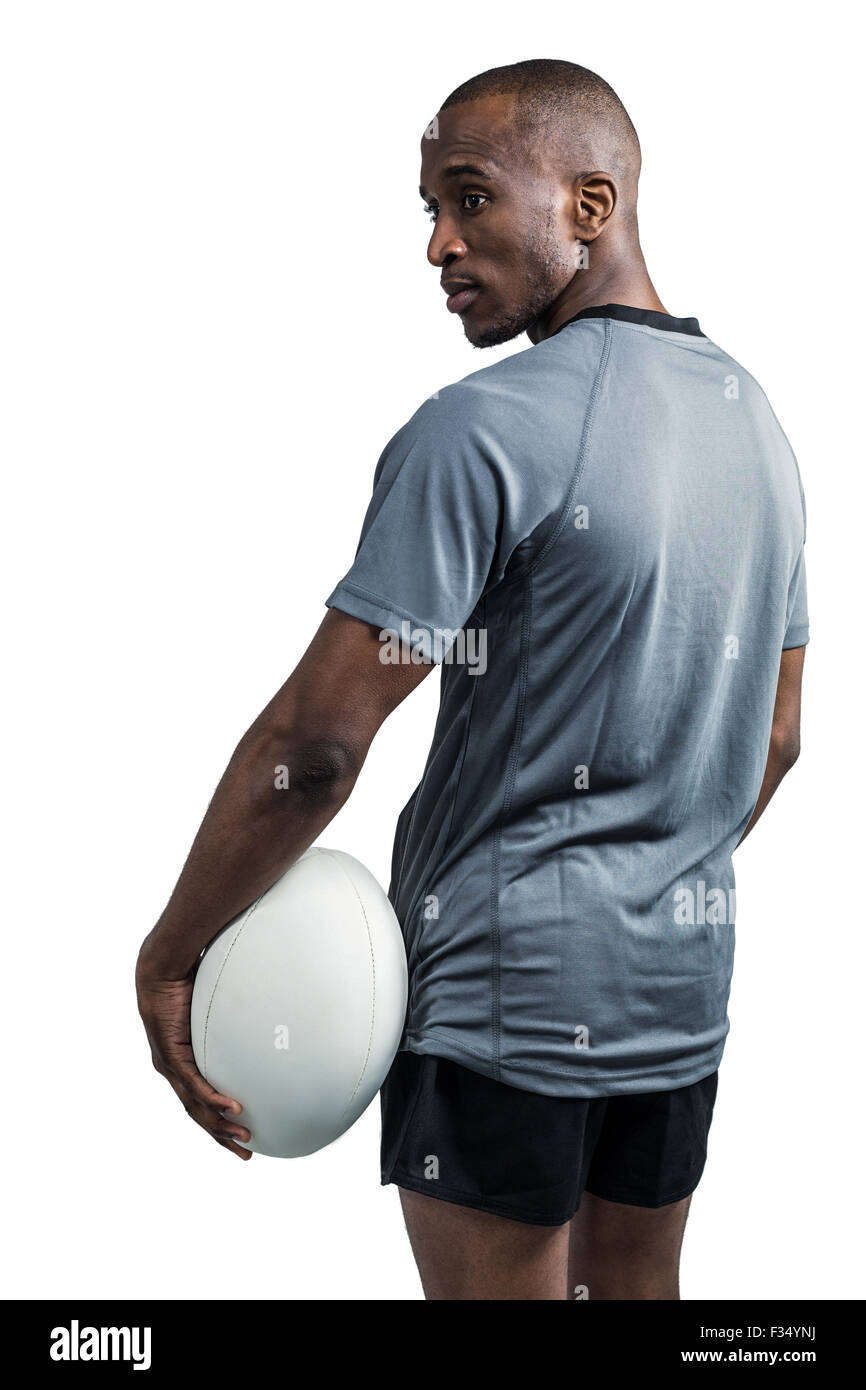 Rear view of confident athlete standing with rugby ball Stock Photo - Alamy