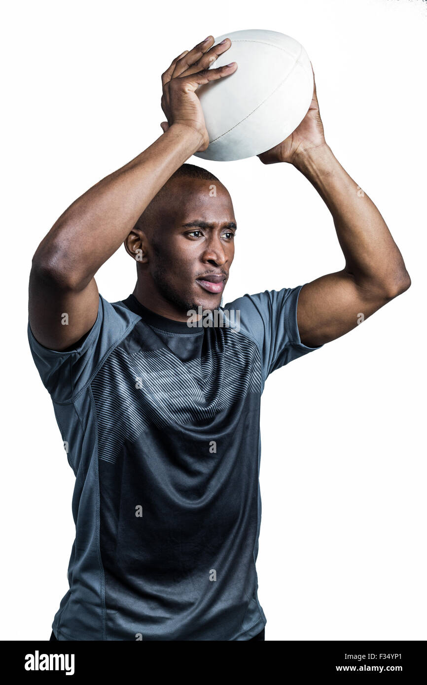 Confident sportsman throwing rugby ball Stock Photo - Alamy