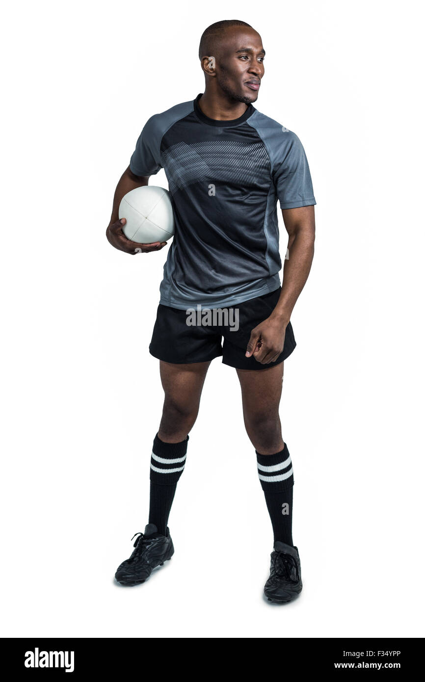 Confident rugby player with ball smiling Stock Photo - Alamy