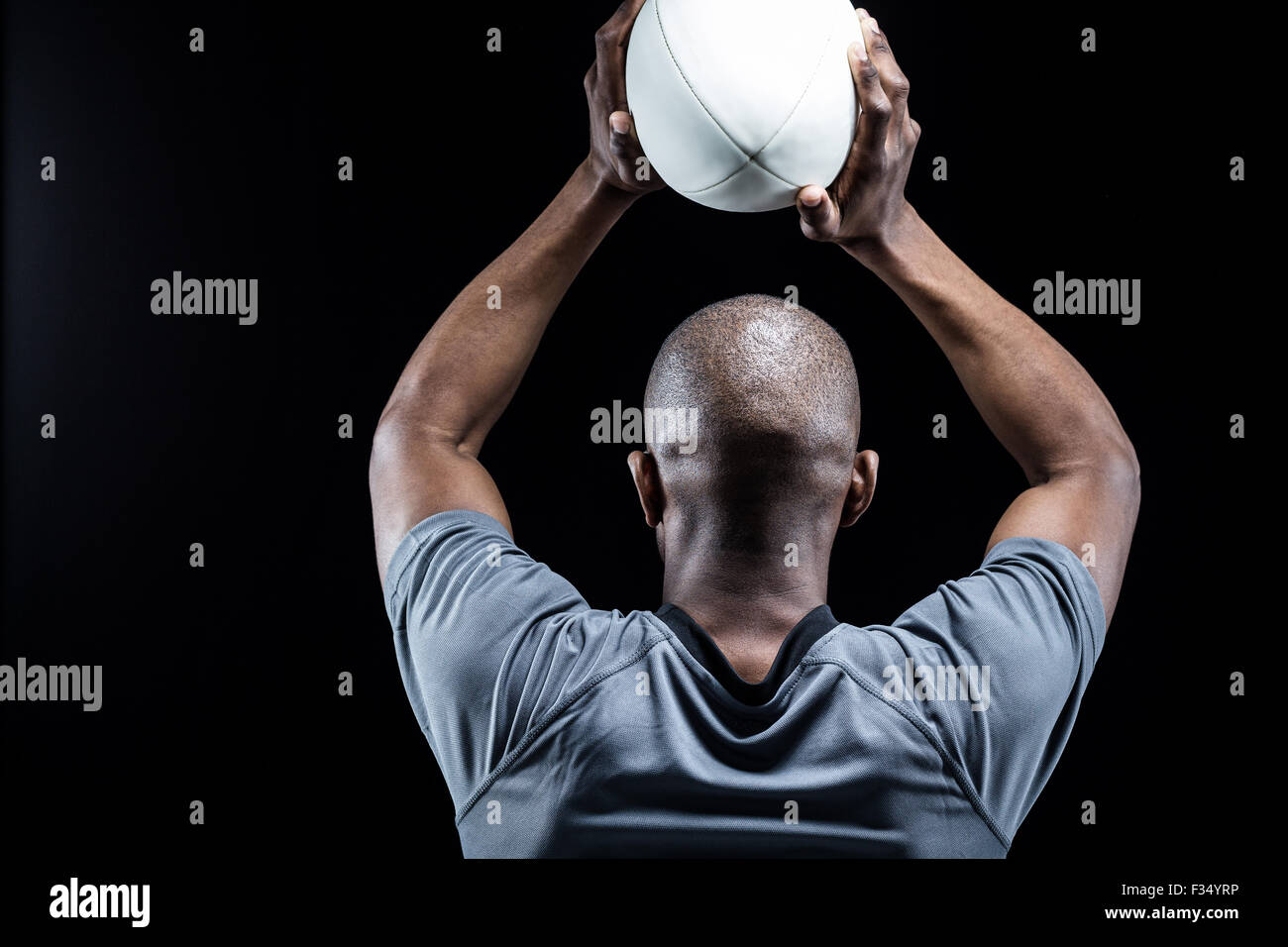 Sportsman throwing rugby ball Stock Photo - Alamy