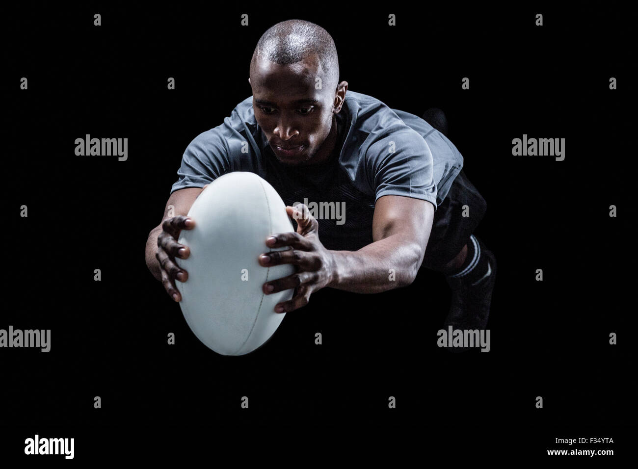 Rugby player jumping while catching ball Stock Photo - Alamy