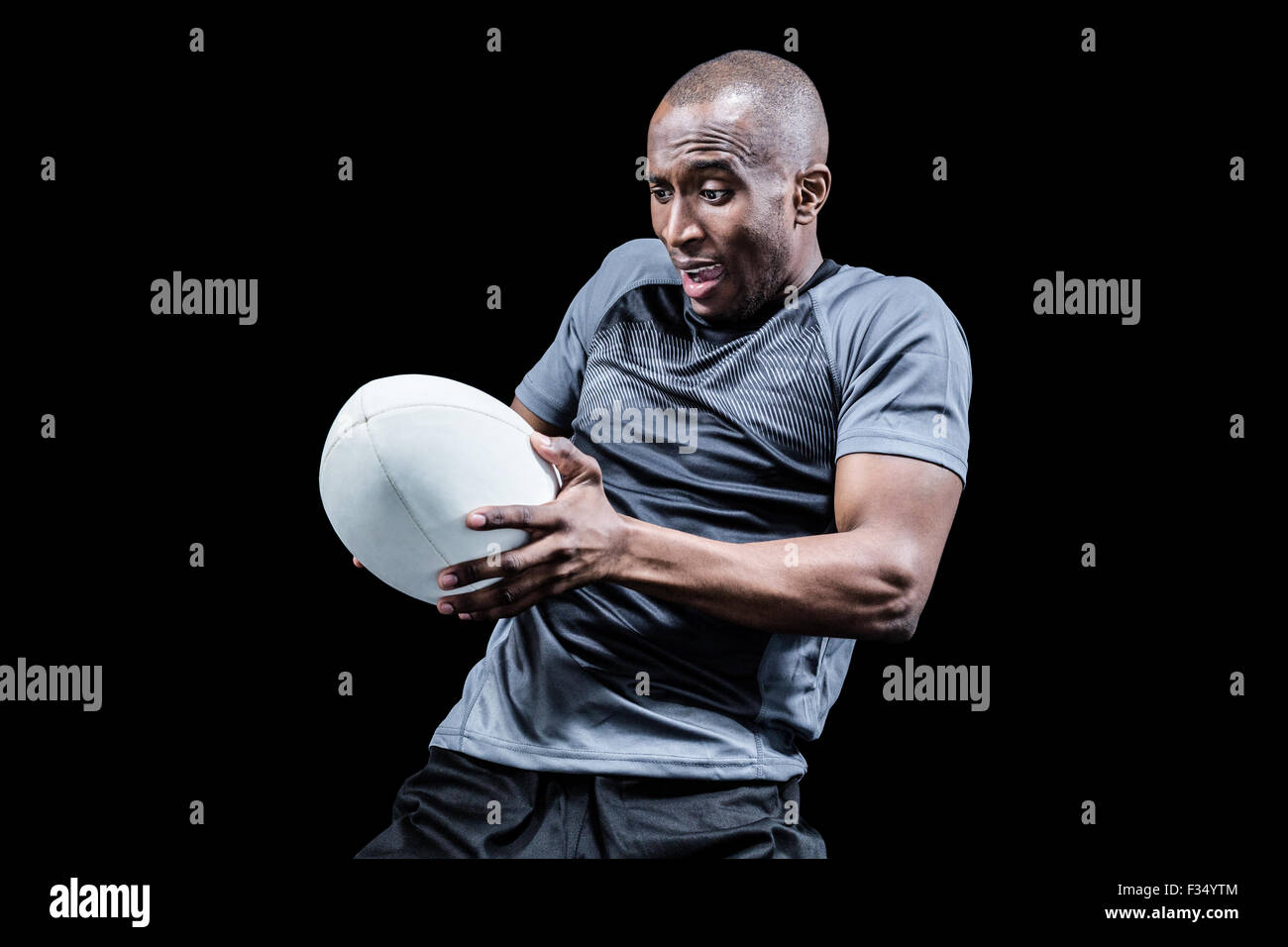 Sportsman catching rugby ball while playing Stock Photo - Alamy