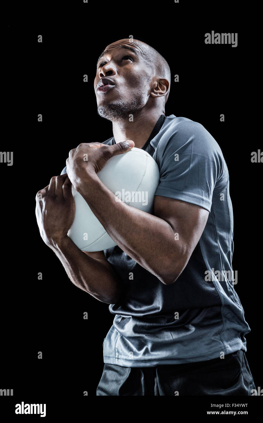 Rugby player catching ball while playing Stock Photo - Alamy