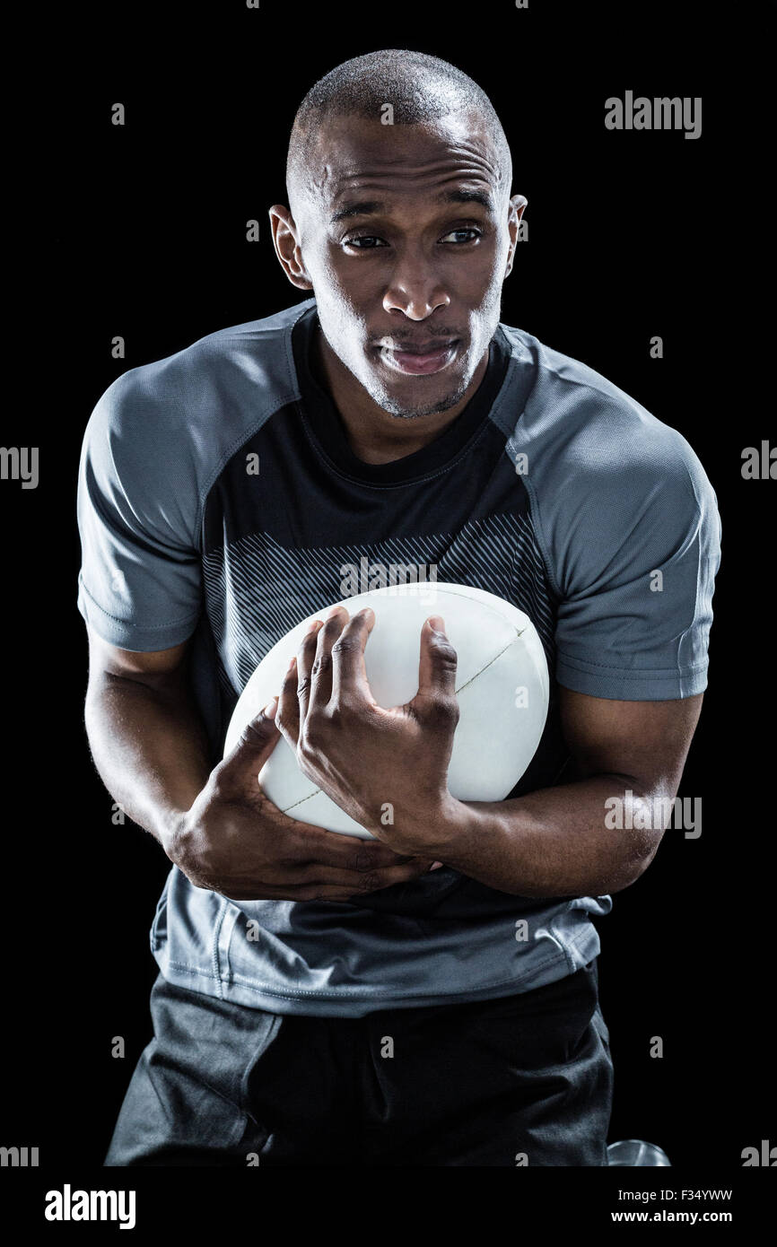 Rugby player smiling while catching ball Stock Photo - Alamy