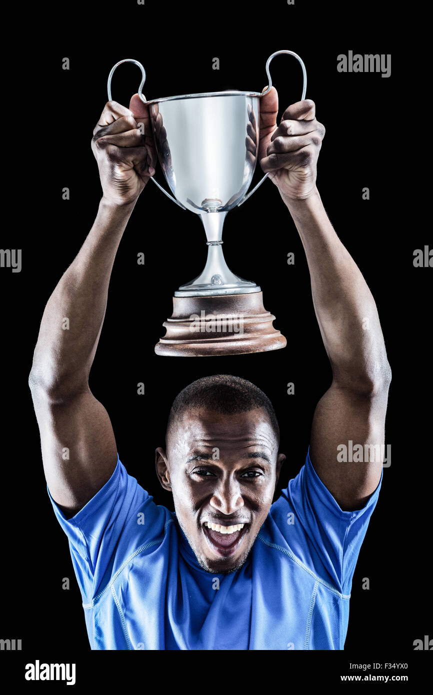 Portrait of happy athlete cheering while holding trophy Stock Photo - Alamy