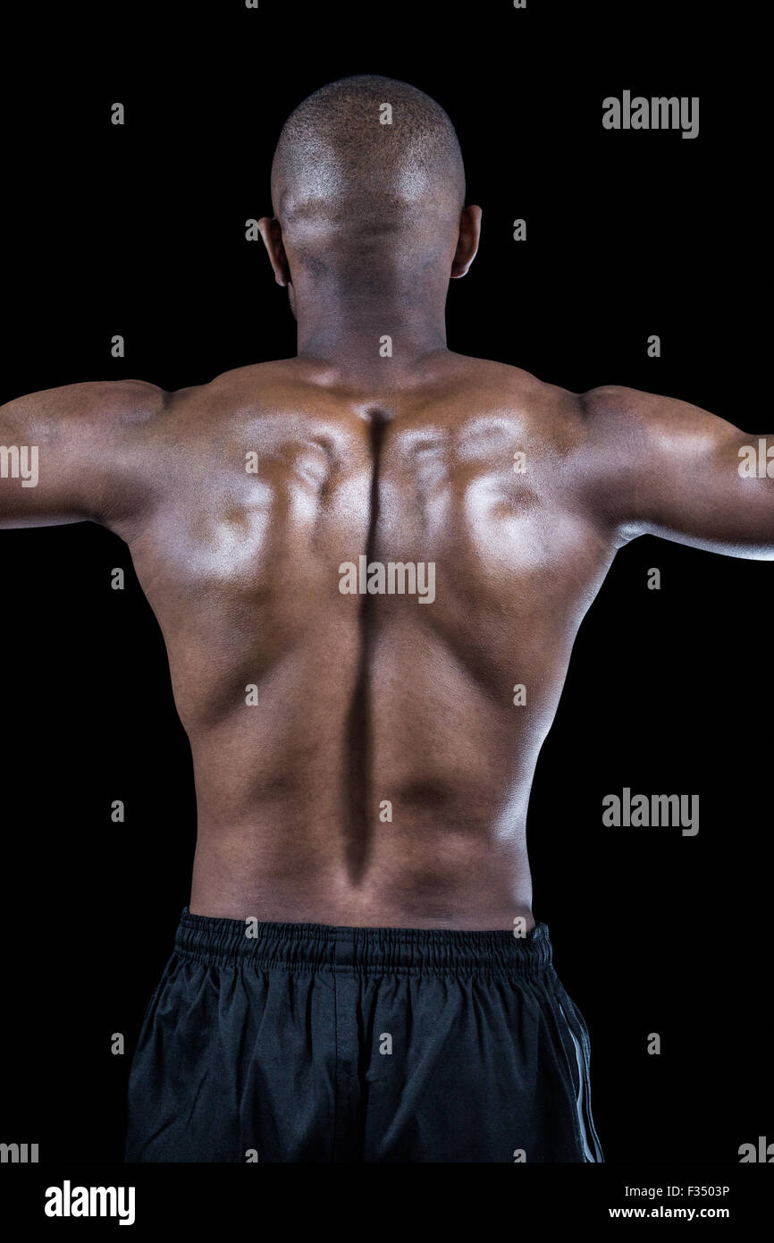 Rear view of shirtless muscular athlete Stock Photo - Alamy