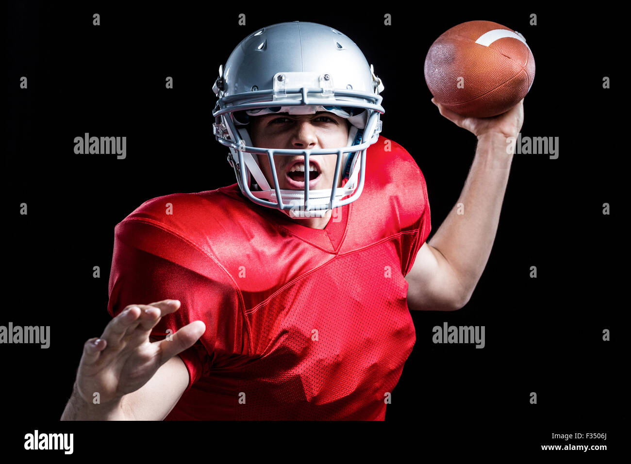 Portrait of American football player throwing ball Stock Photo - Alamy