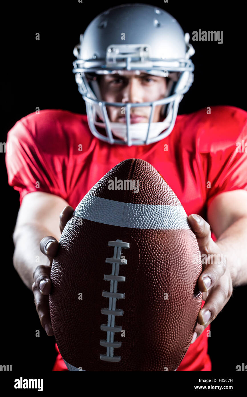 Portrait of sportsman showing American football Stock Photo - Alamy