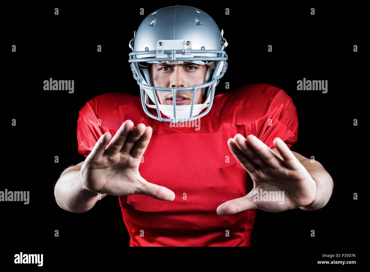 Portrait of American football player defending Stock Photo - Alamy