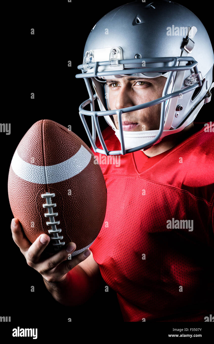 Confident American football player with ball Stock Photo - Alamy