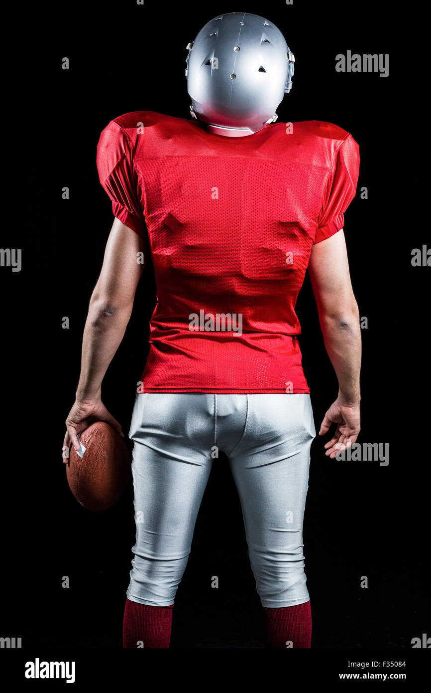 Rear view of American football player with ball Stock Photo - Alamy