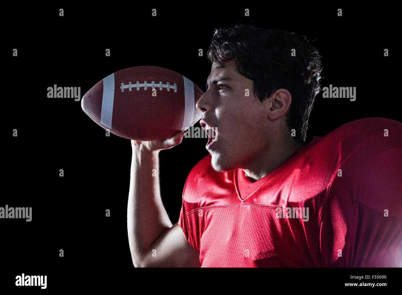 Aggressive sportsman with ball Stock Photo - Alamy