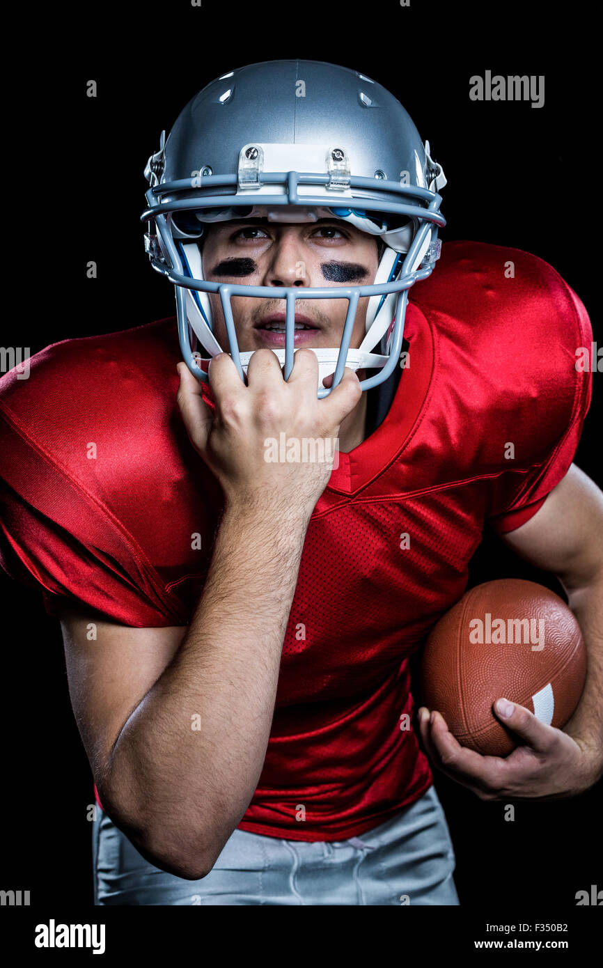 American football player holding helmet Stock Photo - Alamy