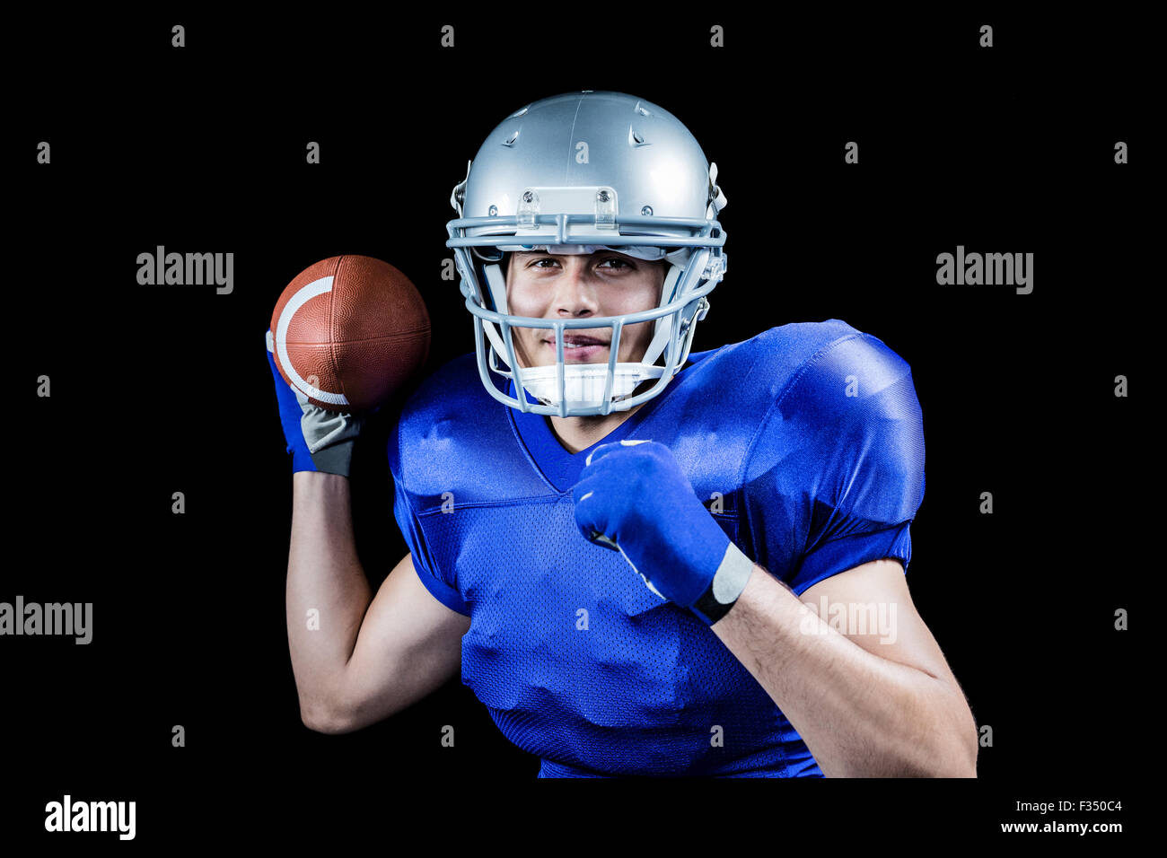 Portrait of sportsman smiling while throwing ball Stock Photo - Alamy