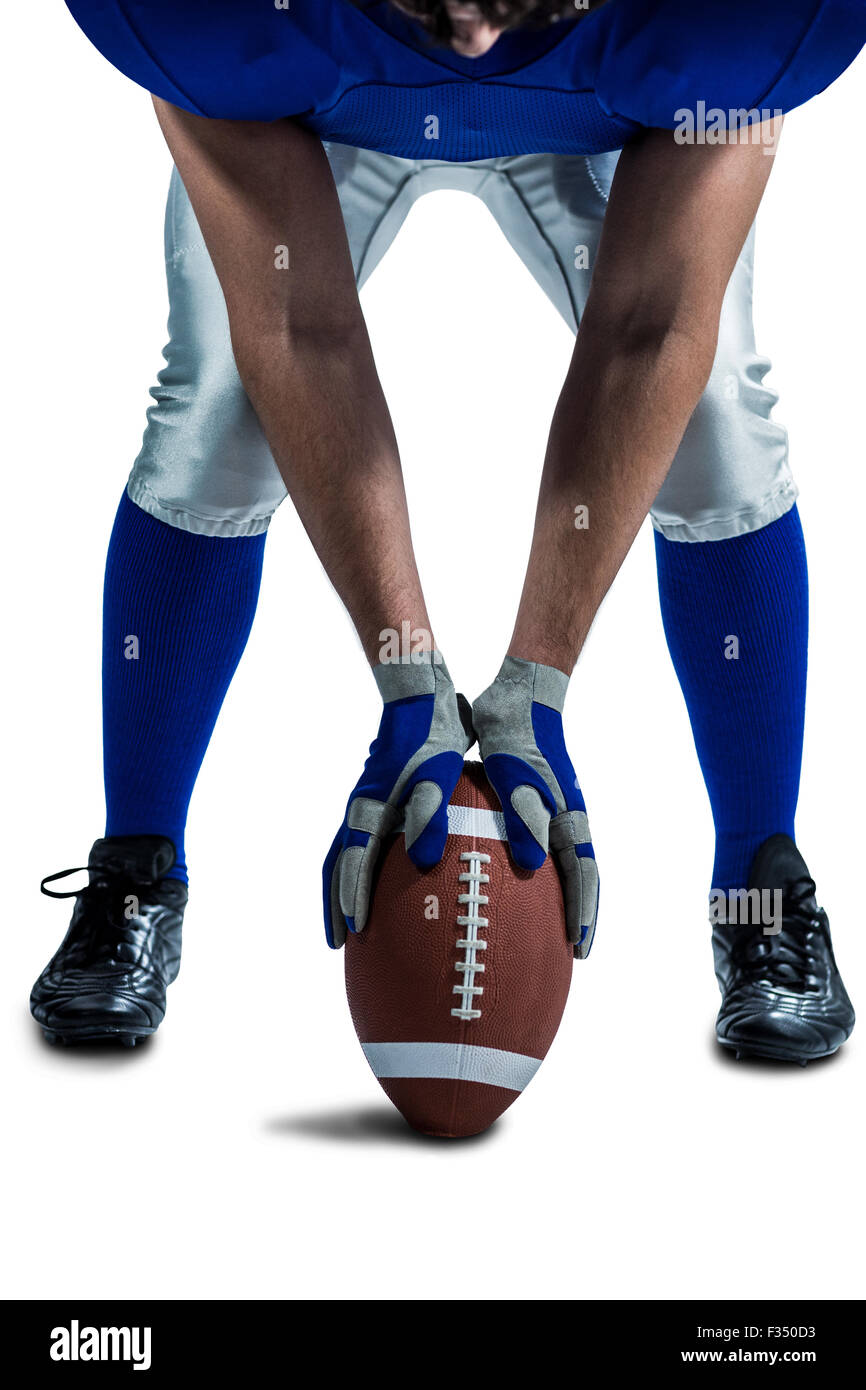 Low section of sportsman placing football Stock Photo - Alamy