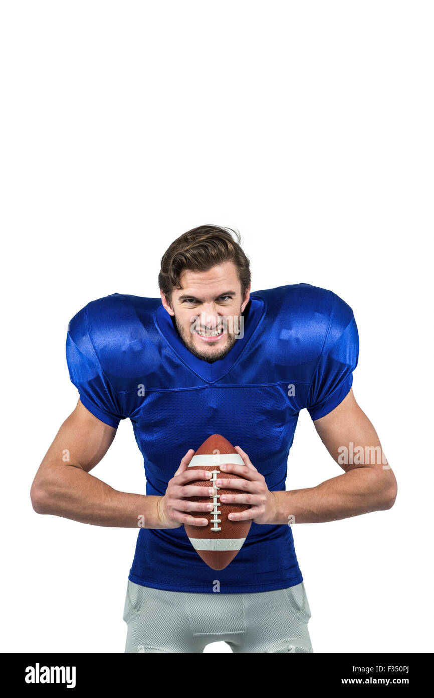 Aggressive american football player holding ball Stock Photo - Alamy