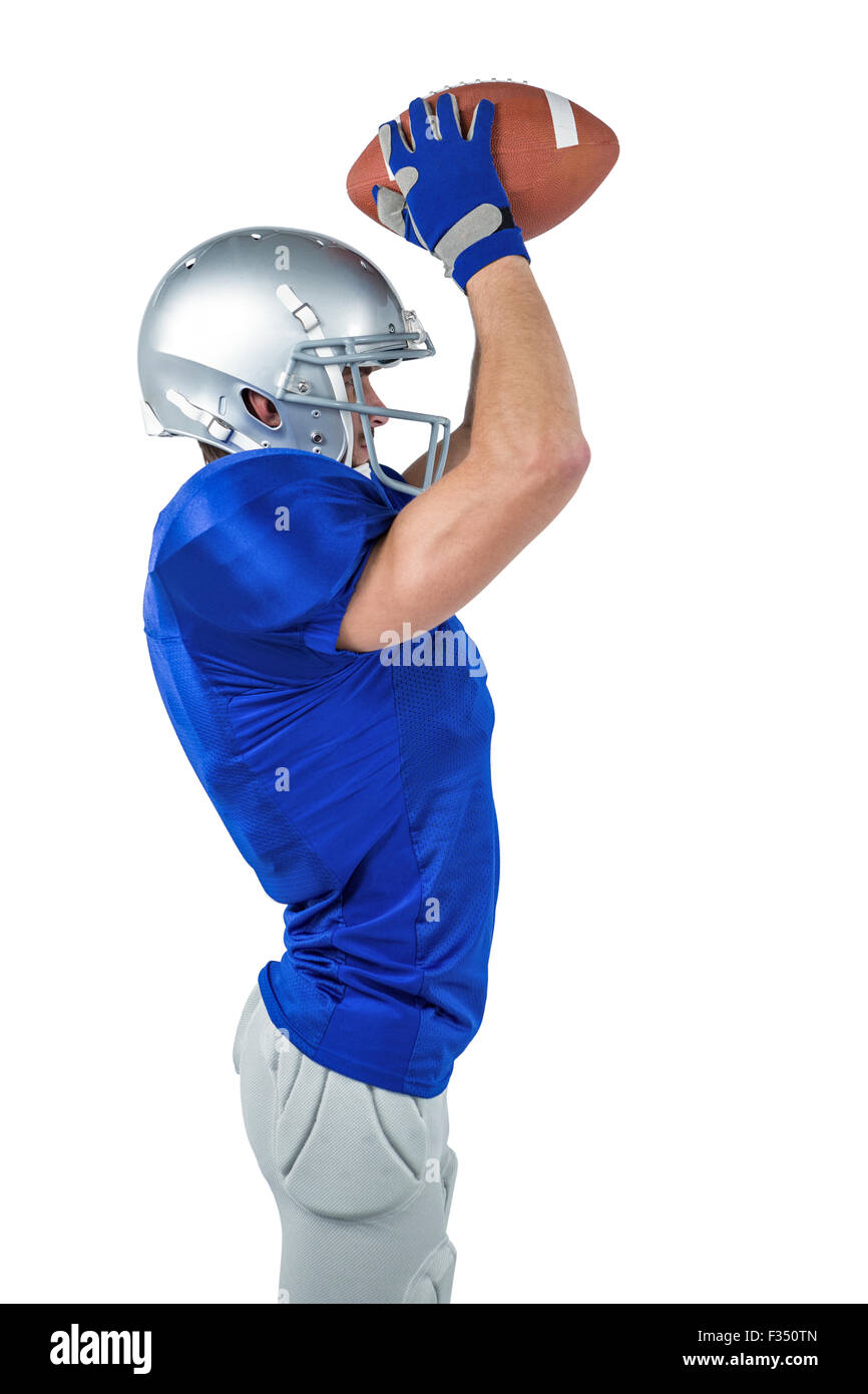 Side view of American football player catching ball Stock Photo - Alamy