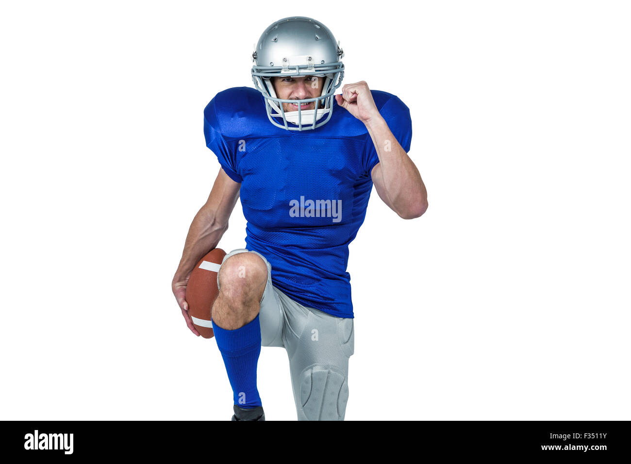 American football player standing on one leg while holding ball Stock ...