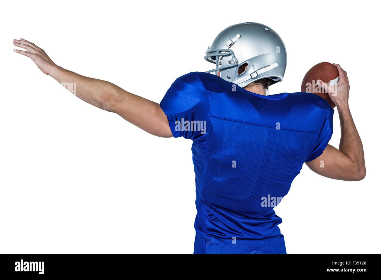 Rear view of American football player throwing ball Stock Photo - Alamy