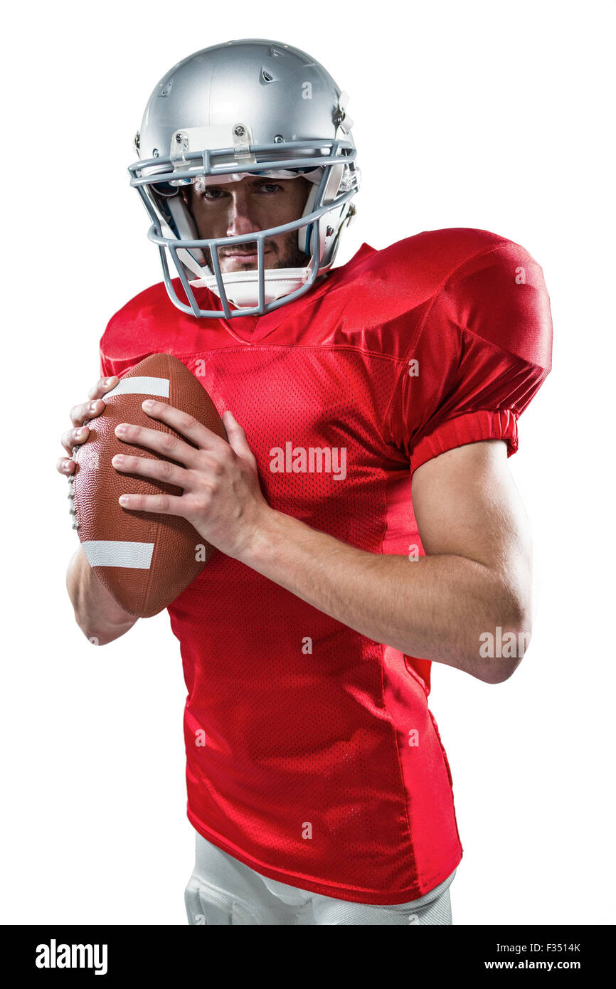 Portrait of confident sports player in red jersey holding ball Stock ...