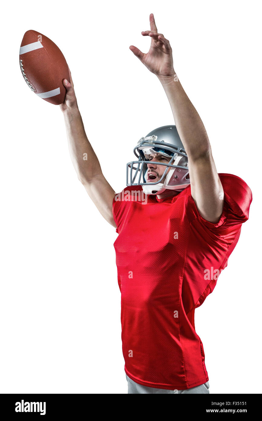 American football player holding ball while pointing up Stock Photo - Alamy