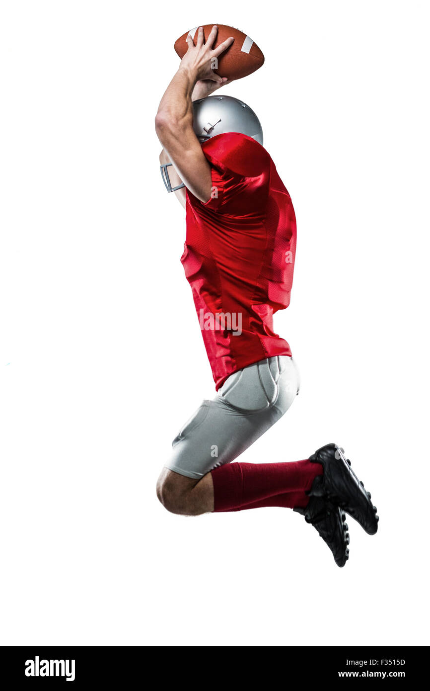 American football player in red jersey jumping Stock Photo - Alamy