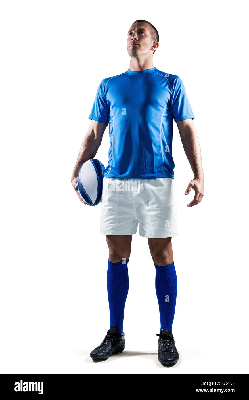 Full length of confident rugby player holding ball Stock Photo - Alamy