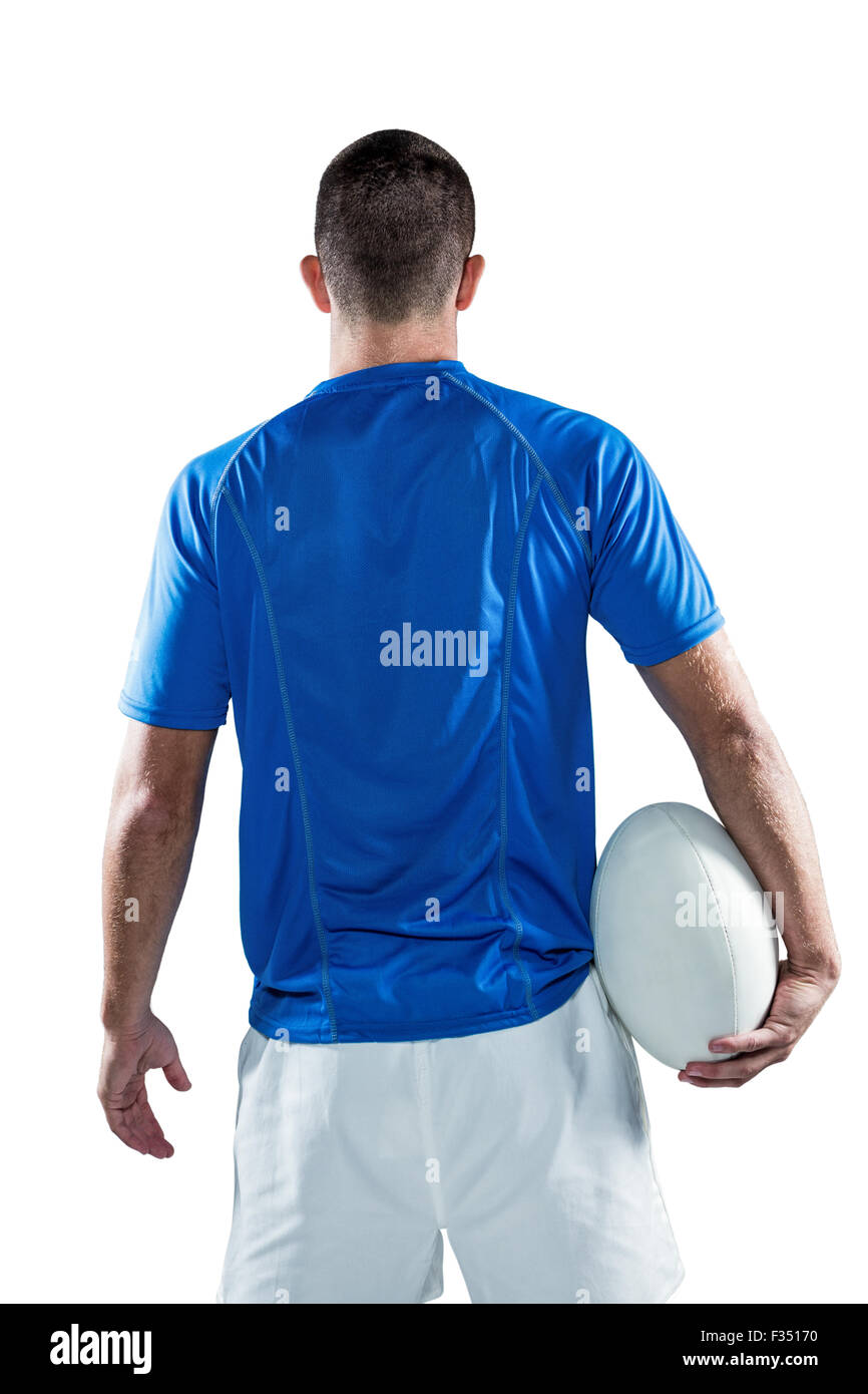 Rear view of rugby player holding ball aside Stock Photo - Alamy