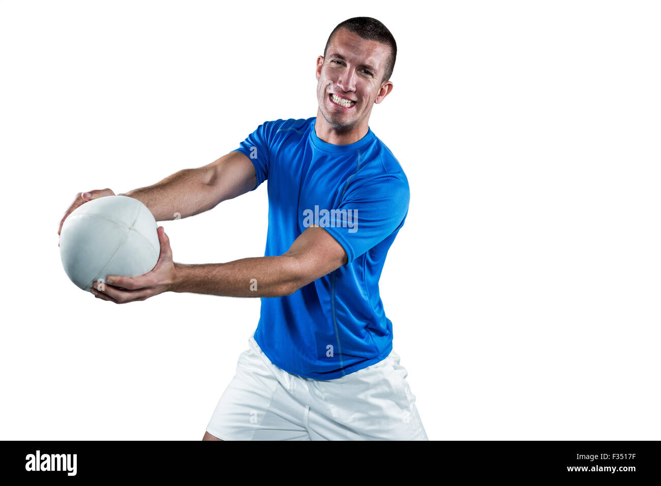 Portrait of smiling rugby player in blue jersey holding ball Stock ...