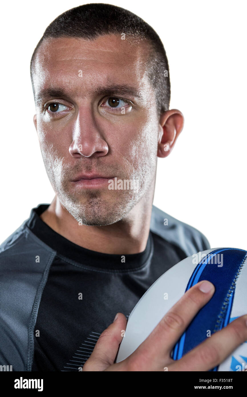 Close-up of confident rugby player holding ball Stock Photo - Alamy
