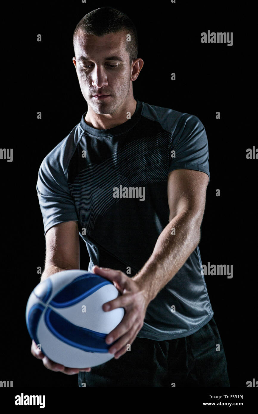 Handsome rugby player holding ball Stock Photo - Alamy