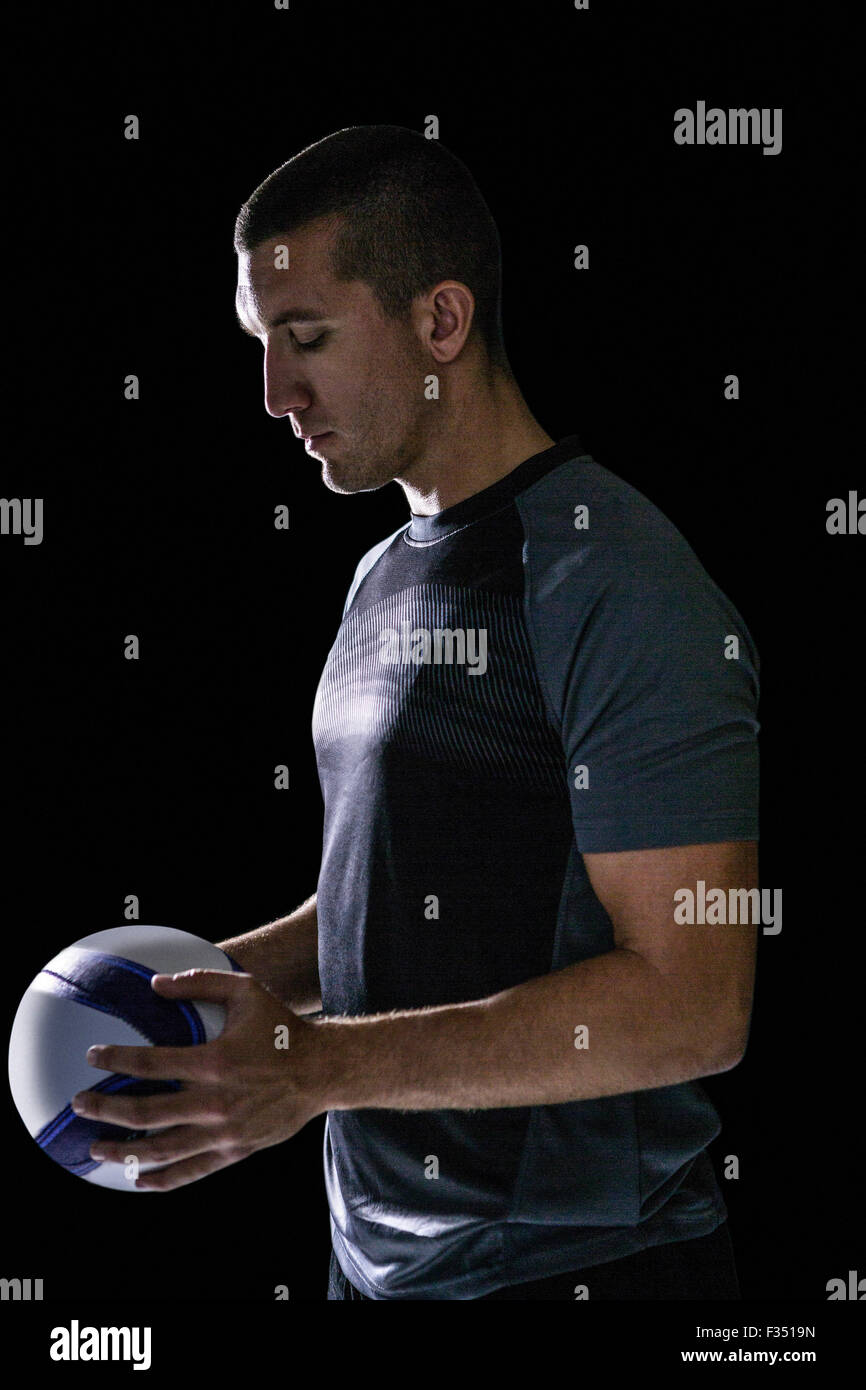 Rugby player thinking while holding ball Stock Photo - Alamy