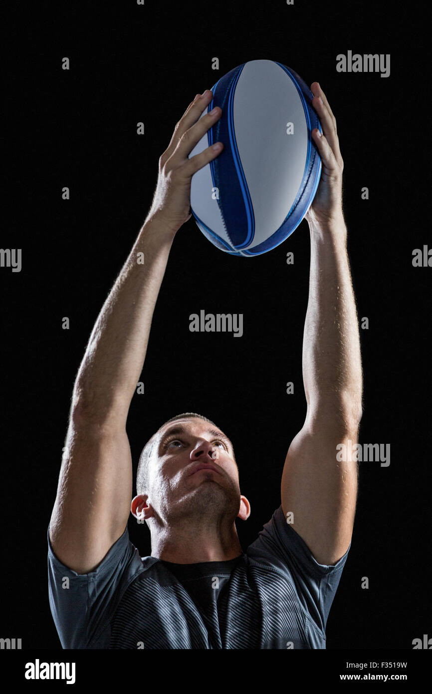 Rugby player throwing ball Stock Photo - Alamy