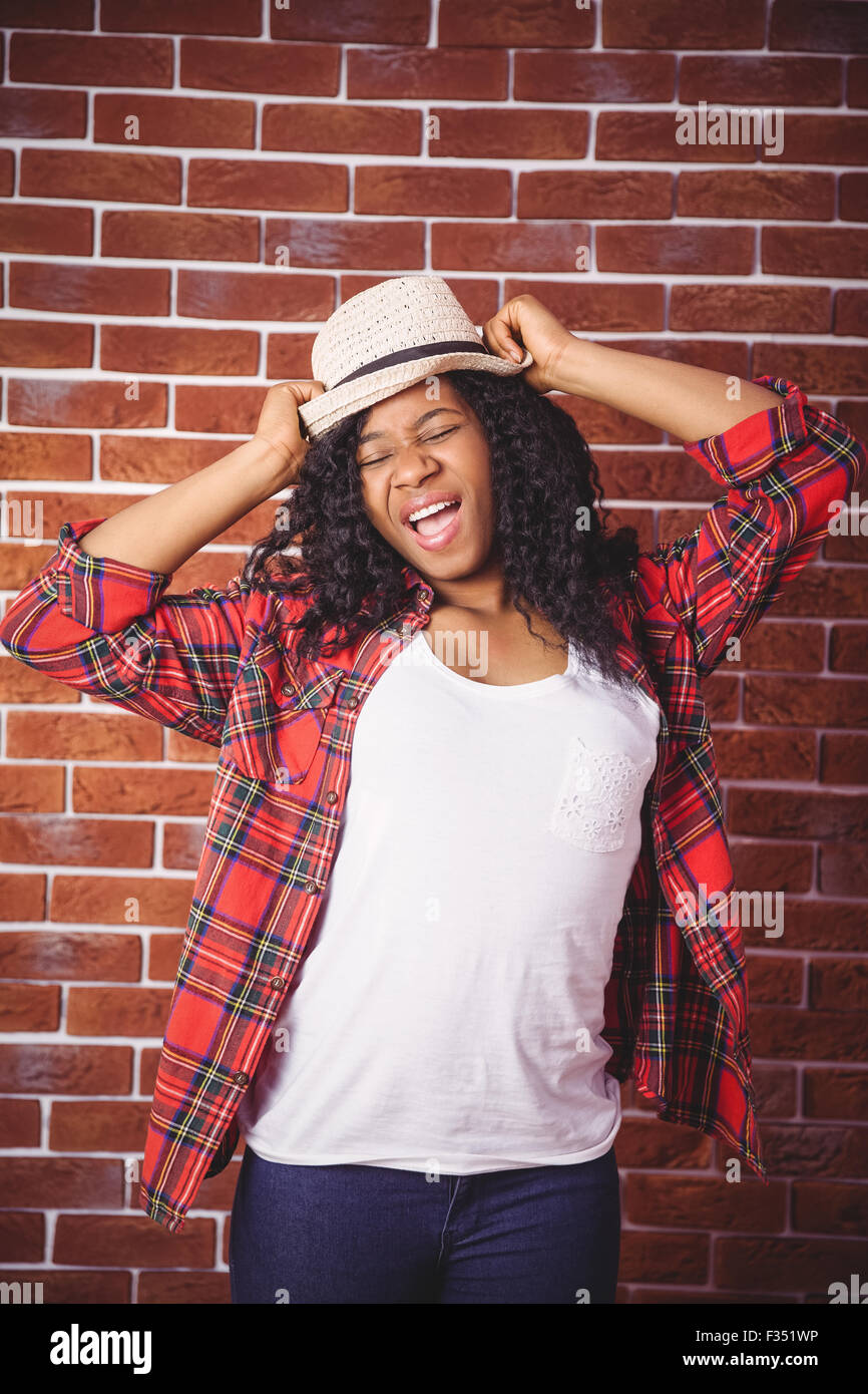 Hipster posing with a hat Stock Photo - Alamy