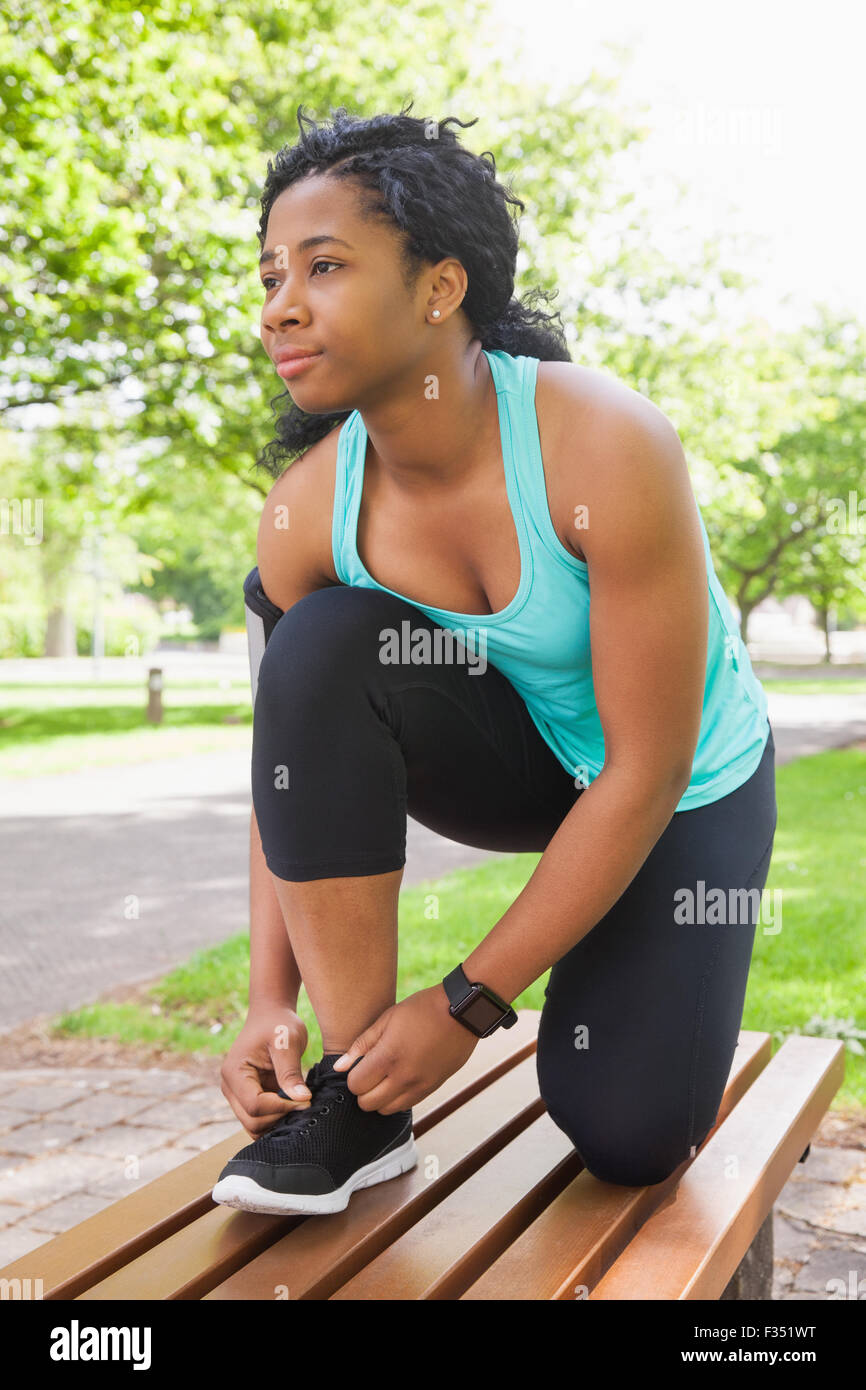 Woman tying her shoelace on running shoe Stock Photo - Alamy