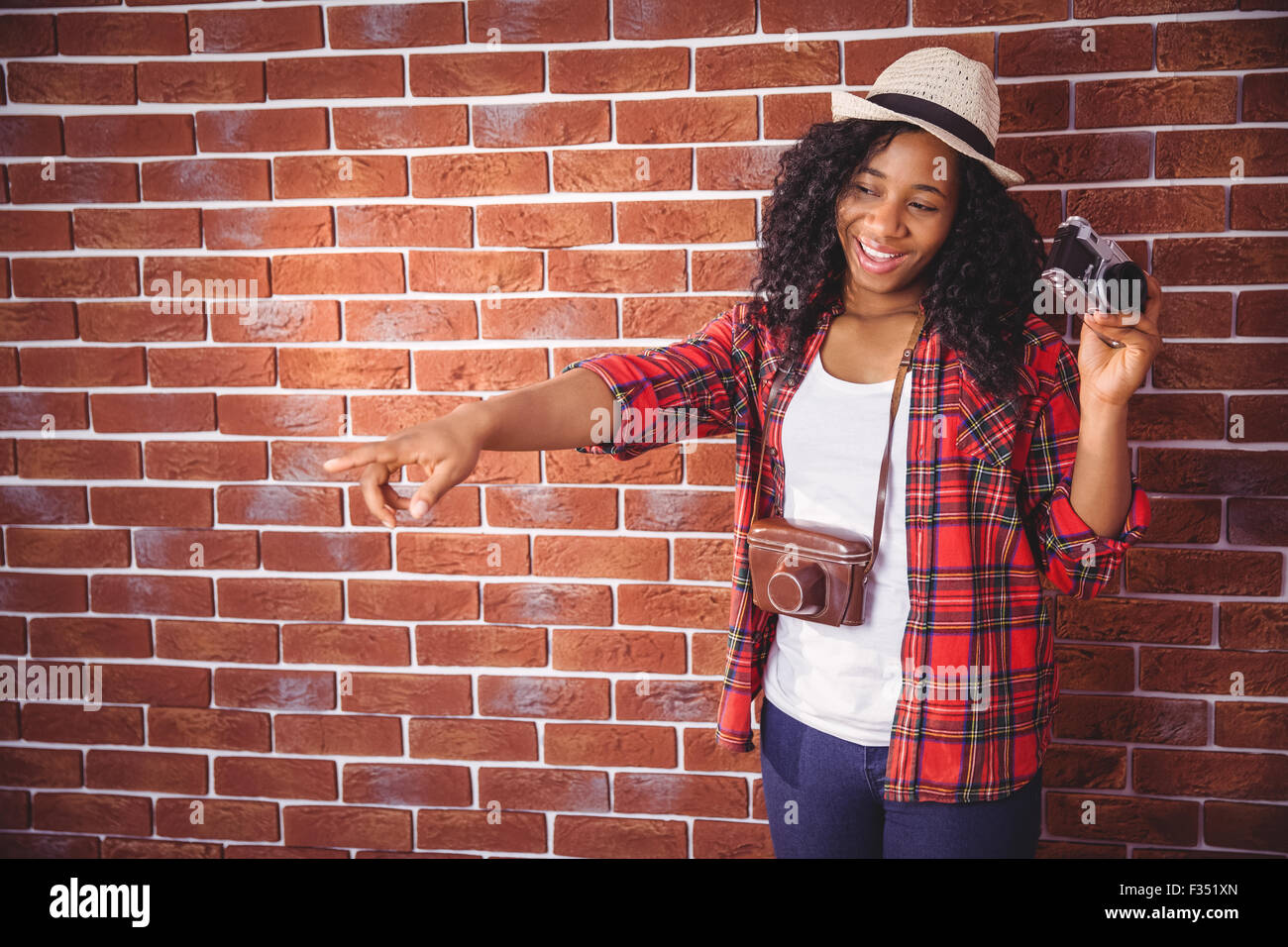 Hipster pointing and holding camera Stock Photo - Alamy