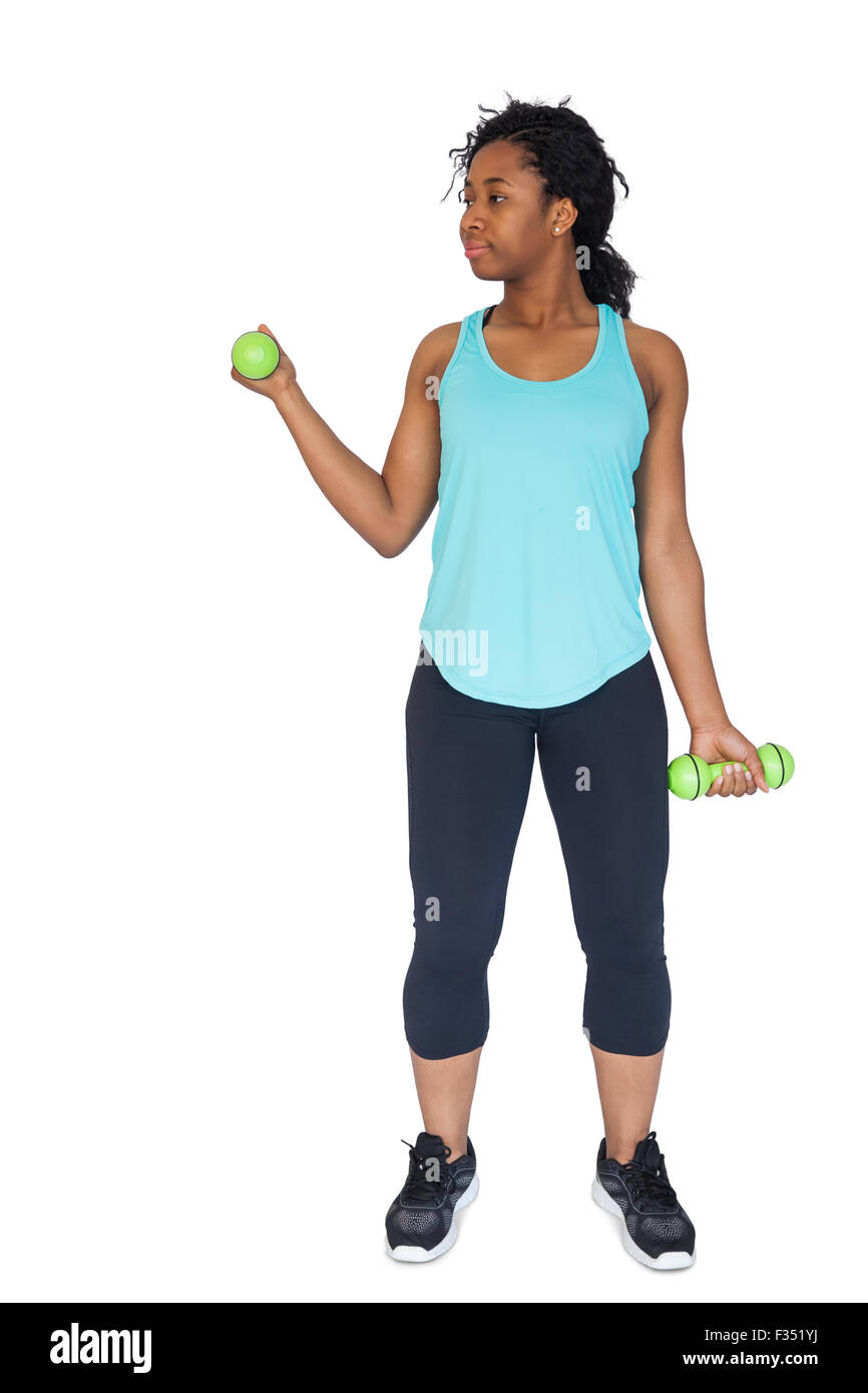 Woman exercising using dumbbells Stock Photo - Alamy