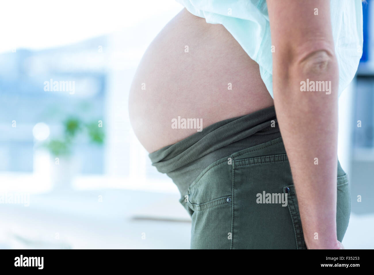 Midsection of pregnant woman Stock Photo - Alamy