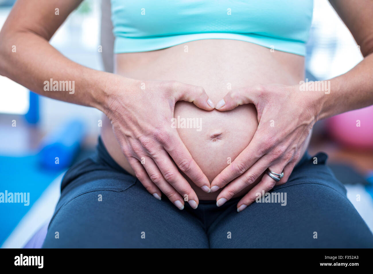 Close-up of pregnant woman touching belly Stock Photo - Alamy