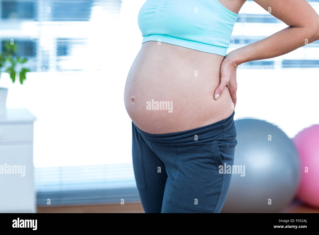Mid section of pregnant woman Stock Photo - Alamy