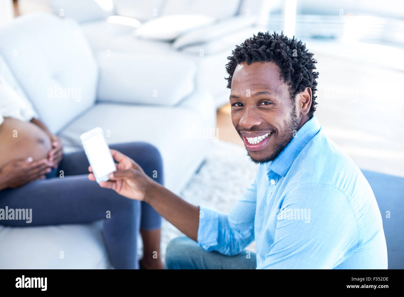Portrait of happy man holding smartphone Stock Photo - Alamy
